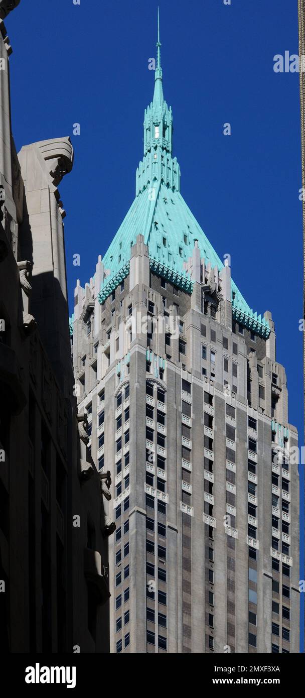 Striking Art Deco skyscraper with a turquoise spire rises against a ...