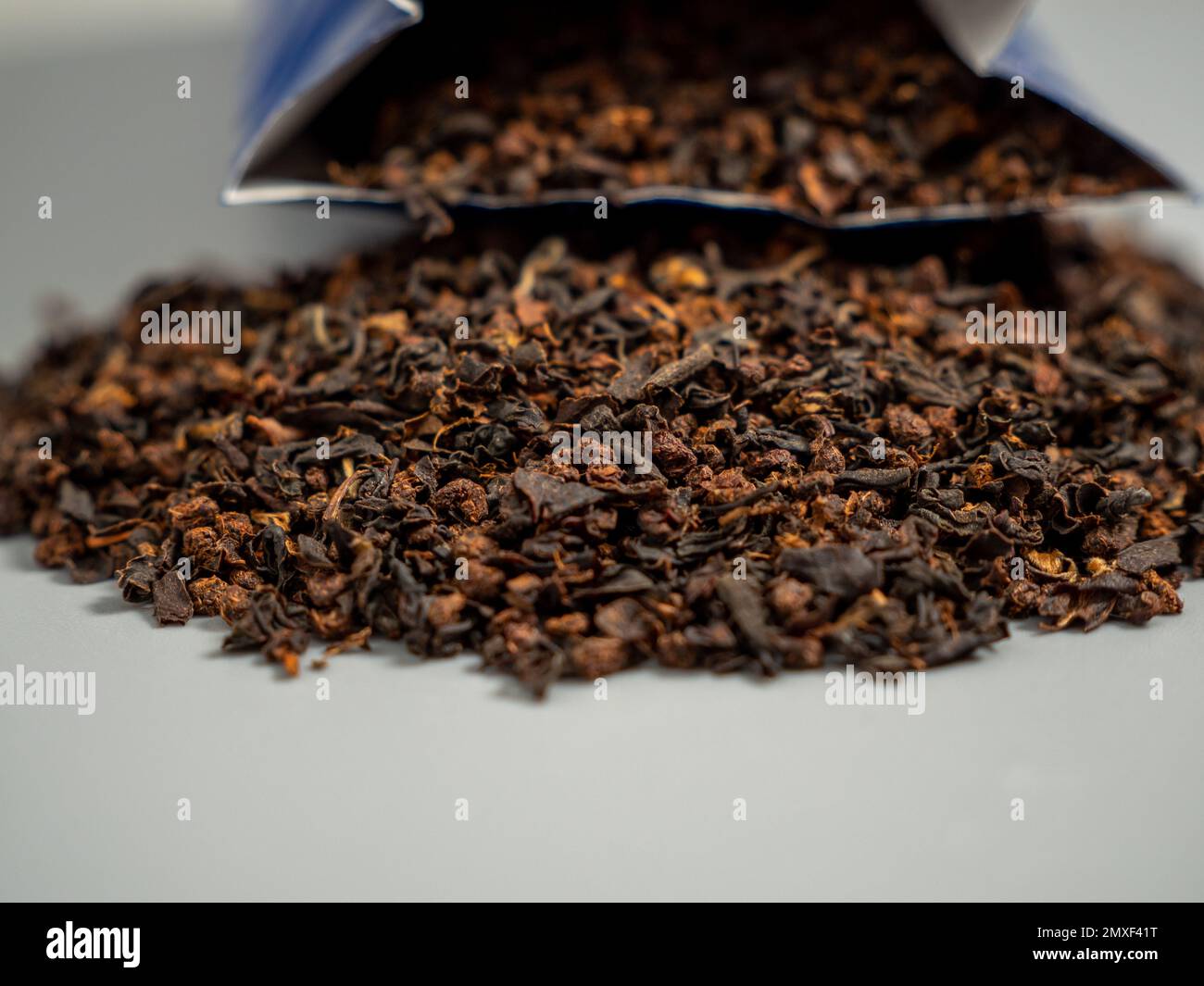 Black tea. Dry brewing of black tea. Black tea packaging Stock Photo ...