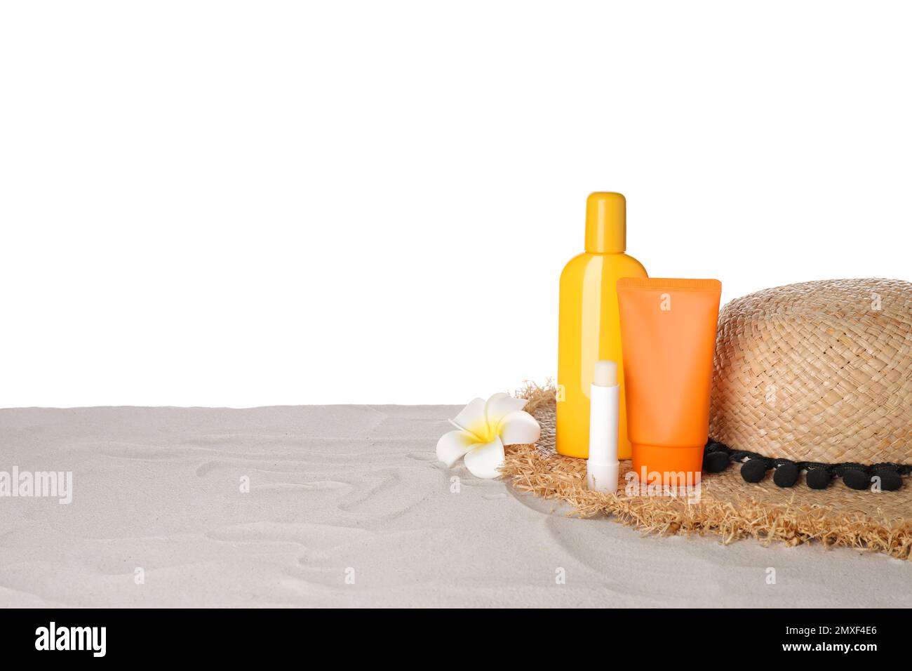 Composition with sun protection products on sand against white ...