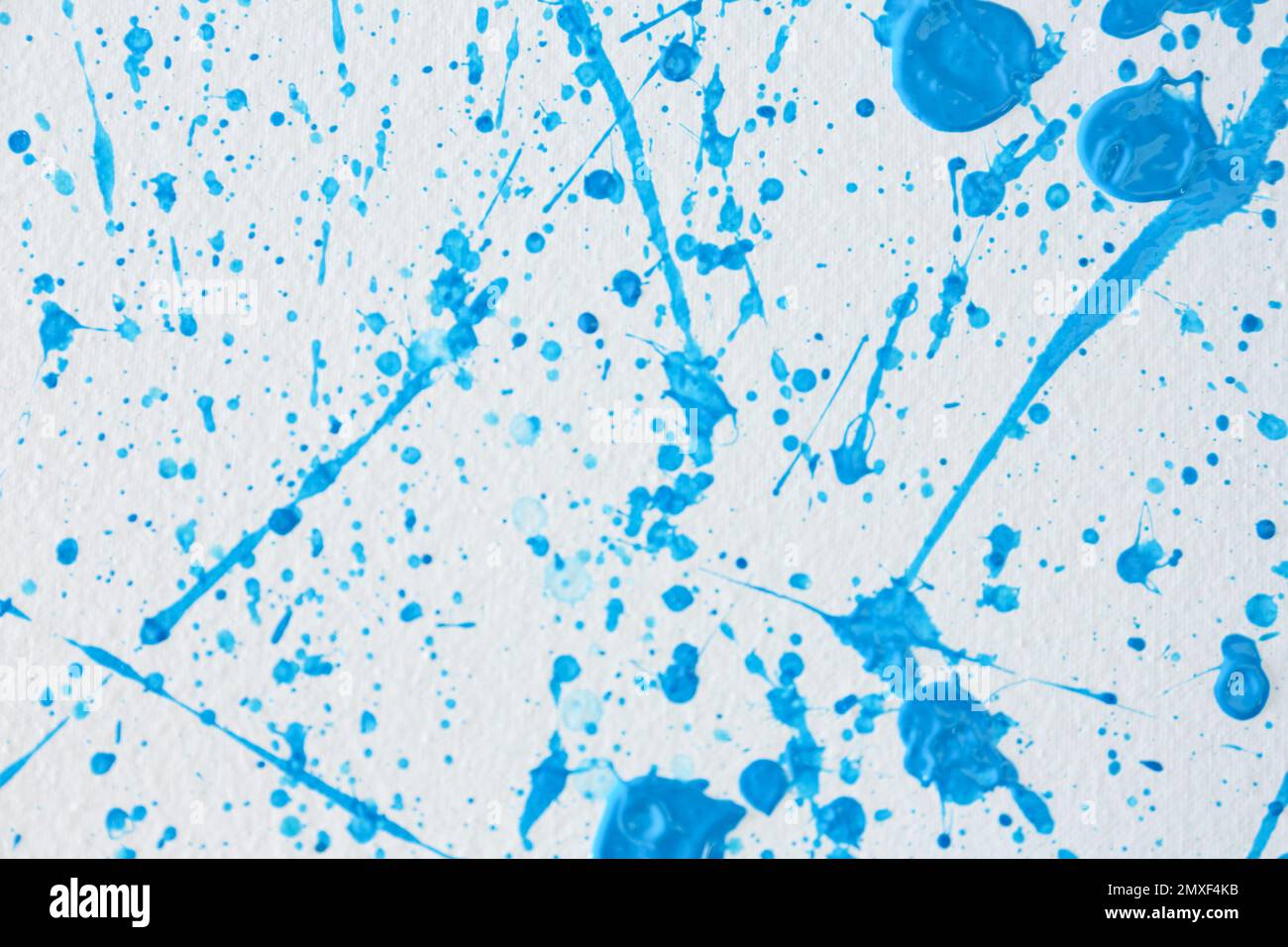 Blue paint splashes on white canvas as background. Art and creativity ...