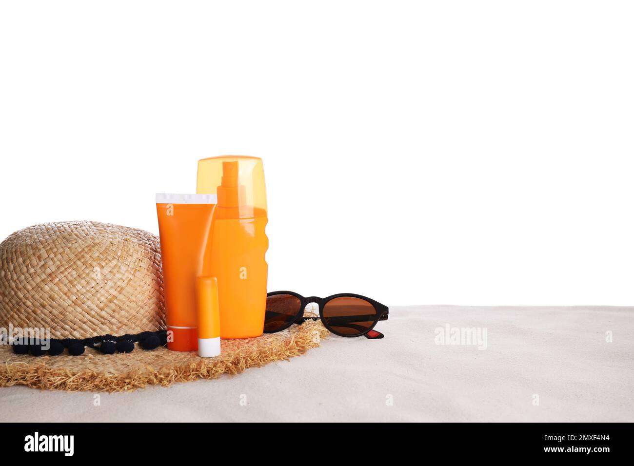 Sun protection cosmetic products and beach accessories on sand. Space ...