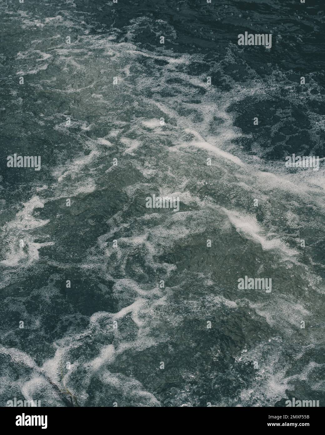 A vertical shot of foamy water texture Stock Photo - Alamy