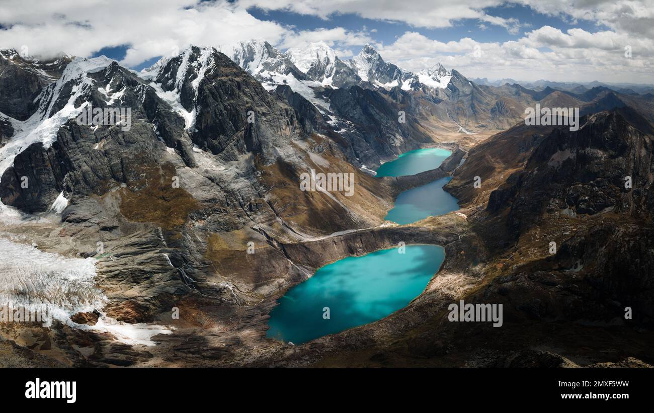 The Huayhuash Mountain Range over the azure lagoons in Peru Stock Photo ...