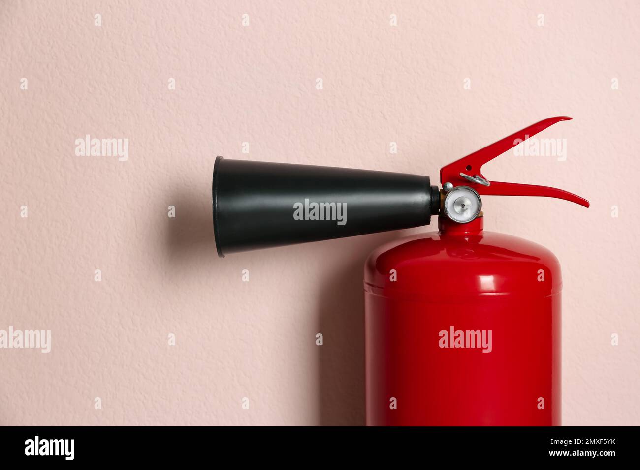 Fire extinguisher on pink background, closeup view Stock Photo - Alamy