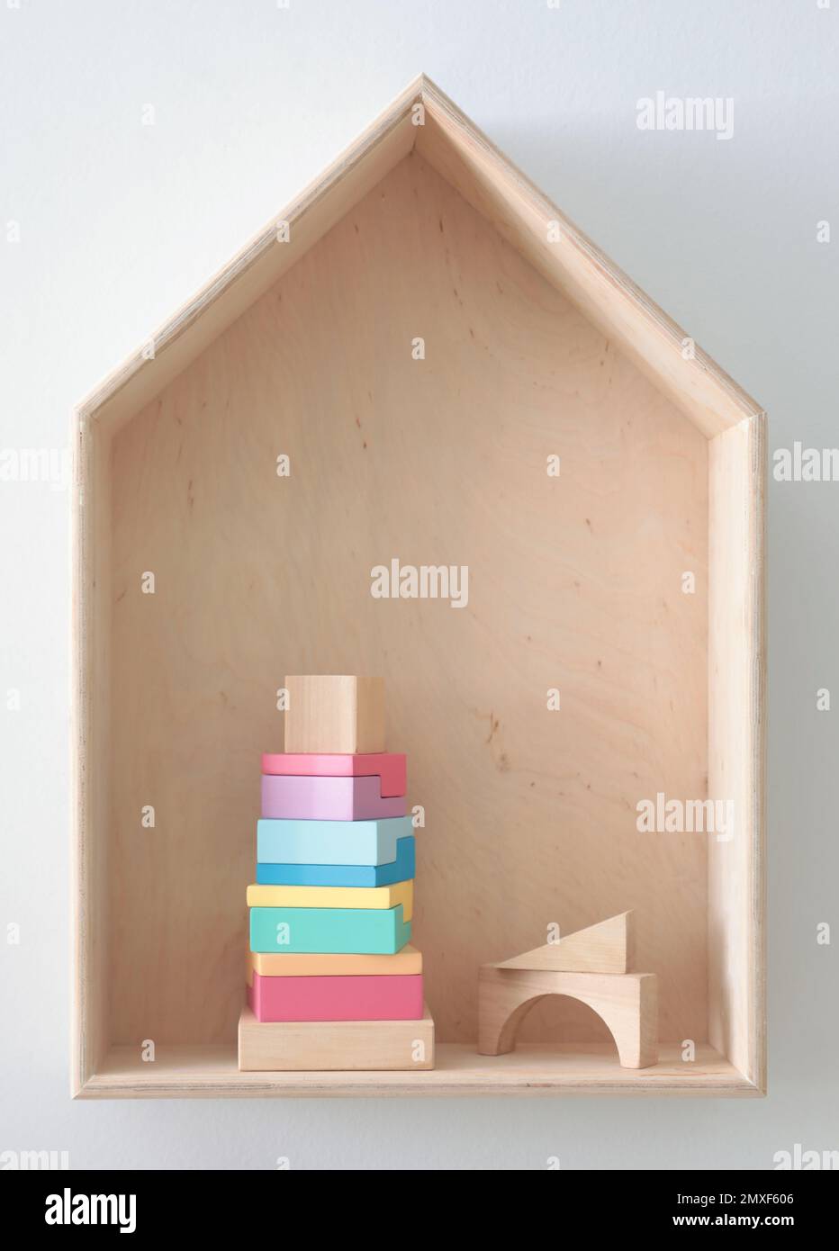 House shaped shelf with toys on white wall. Interior design Stock Photo ...
