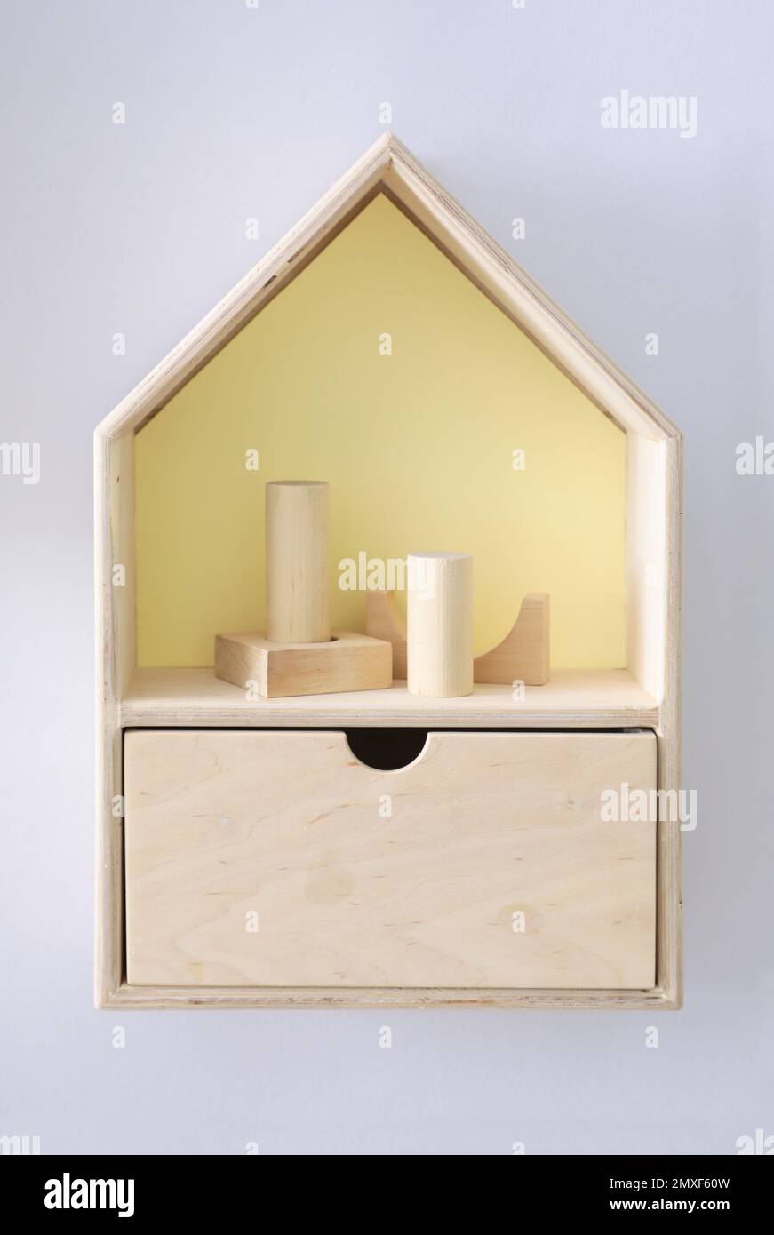 House shaped shelf with toys on white wall. Interior design Stock Photo ...