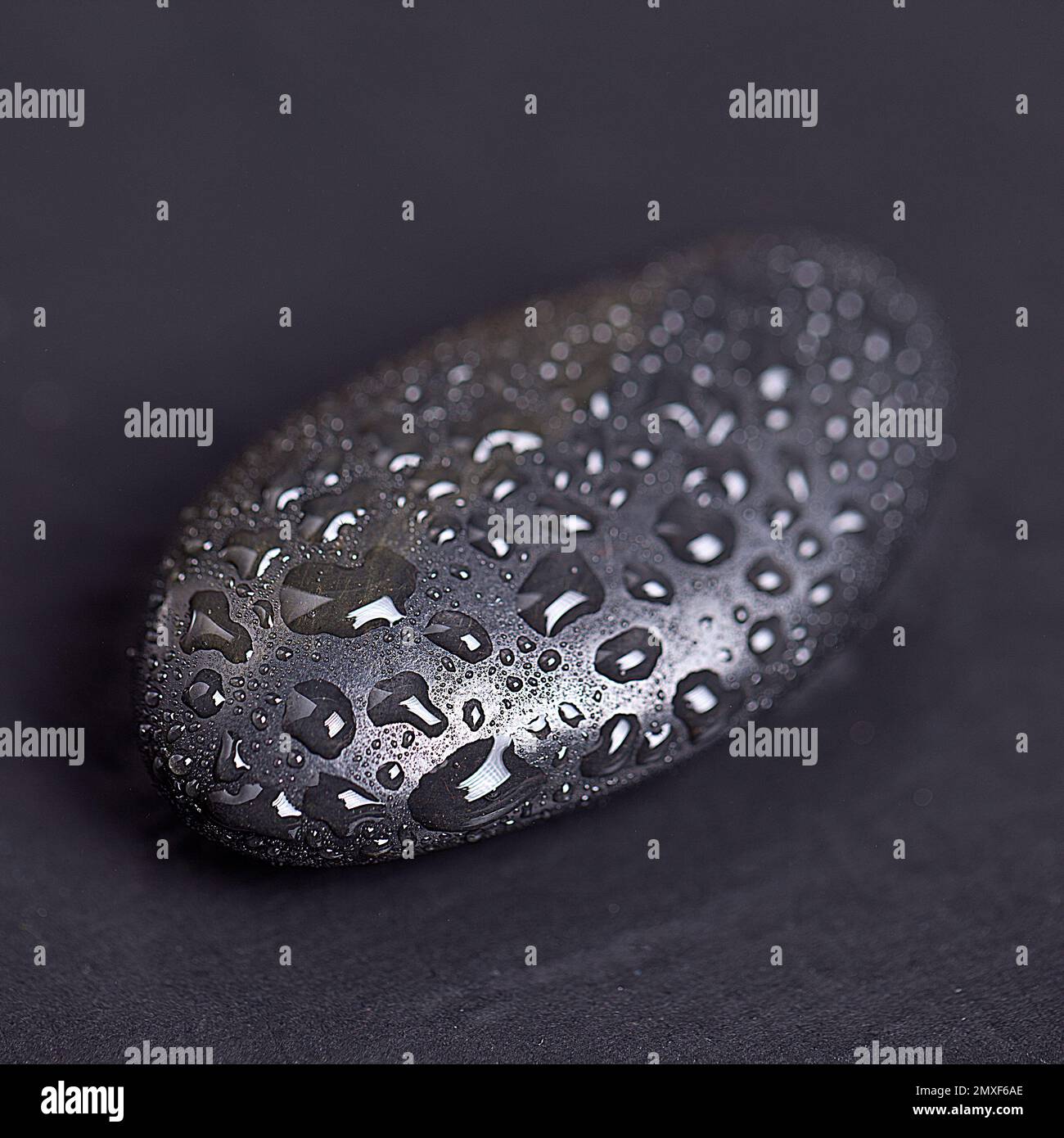 Black Stone with water drops Stock Photo - Alamy