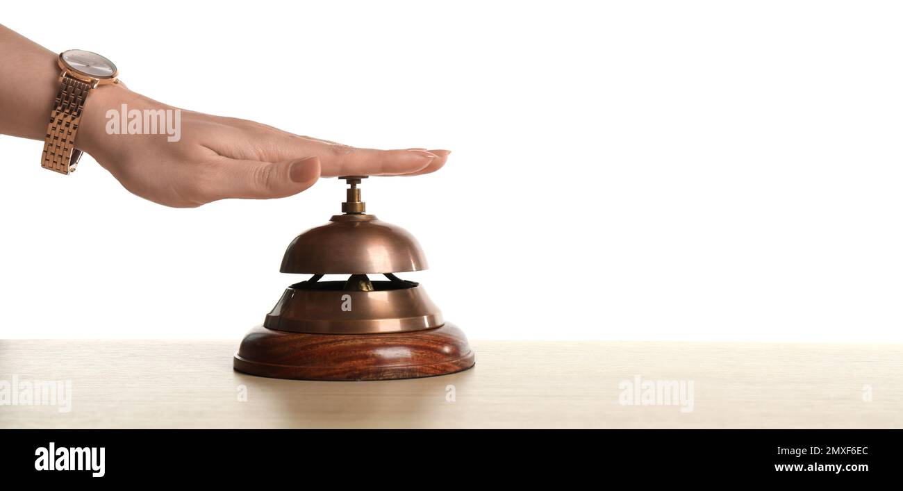 Woman ringing hotel service bell at wooden table Stock Photo - Alamy