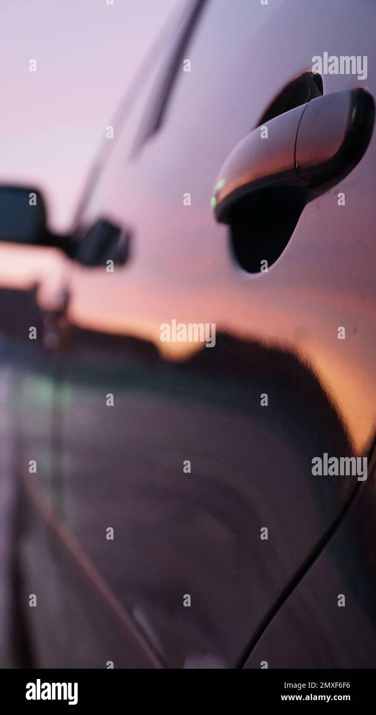 A sunset reflecting in the car Stock Photo - Alamy