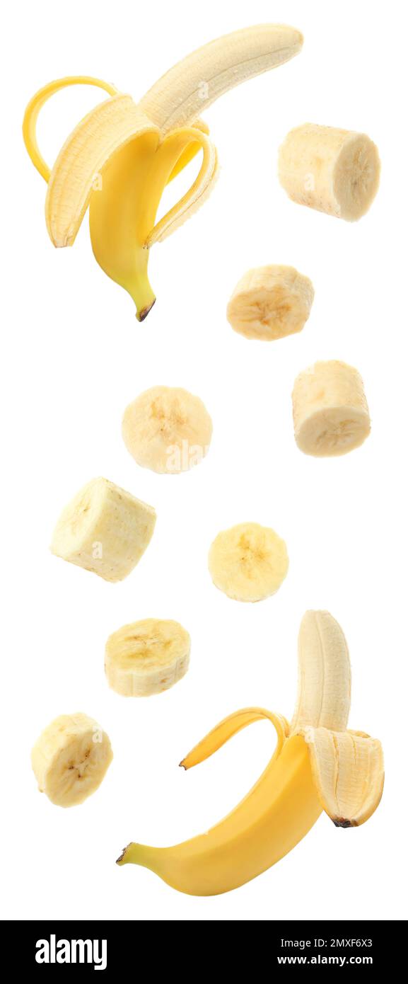 Set with delicious ripe bananas and pieces falling on white background ...
