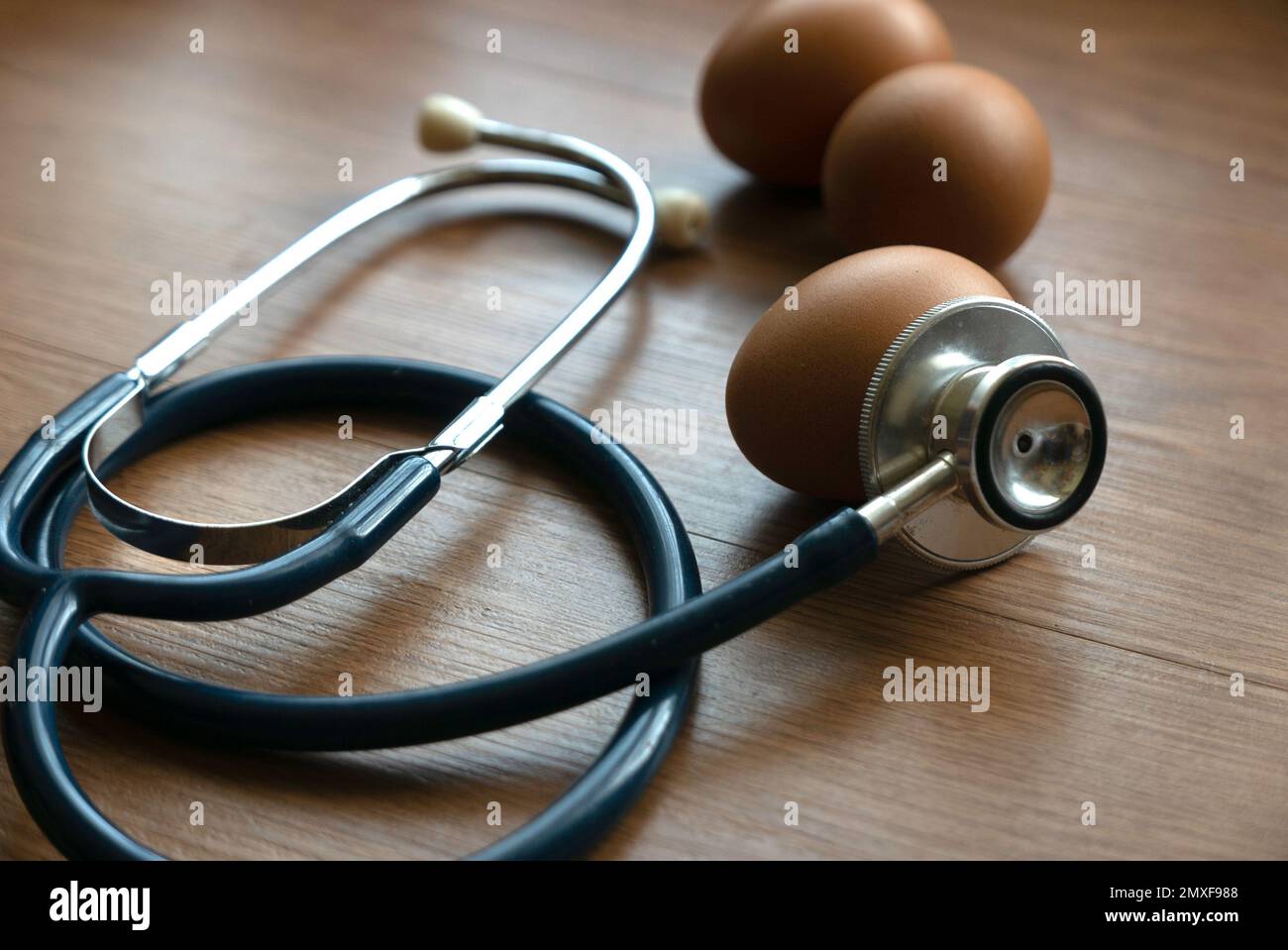 Eggs and stethoscope on wooden table. Health, diet and nutrition ...