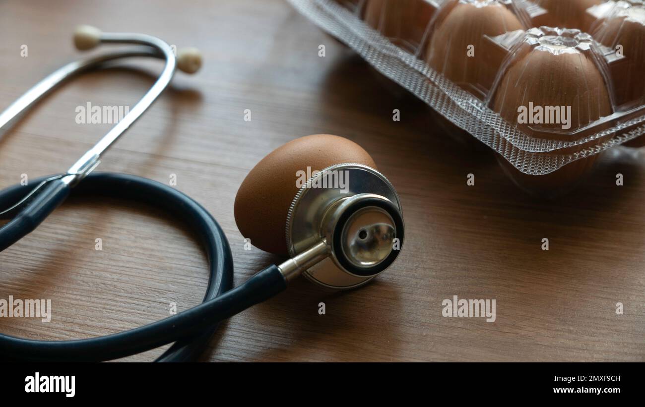 Eggs and stethoscope on wooden table. Health, diet and nutrition ...