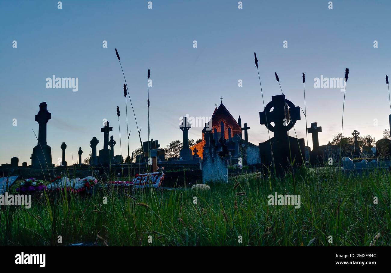 Picture of an old cemetery in Ireland at dusk from a ground perspective ...