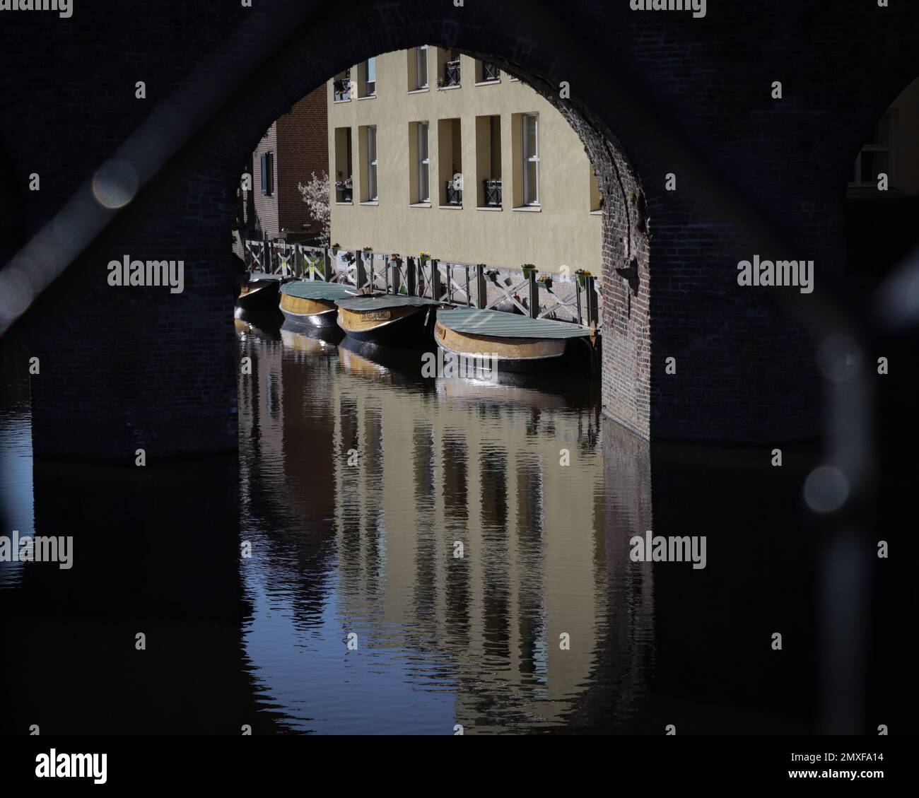 A beautiful view through the city walls of the medieval town Zutphen in ...