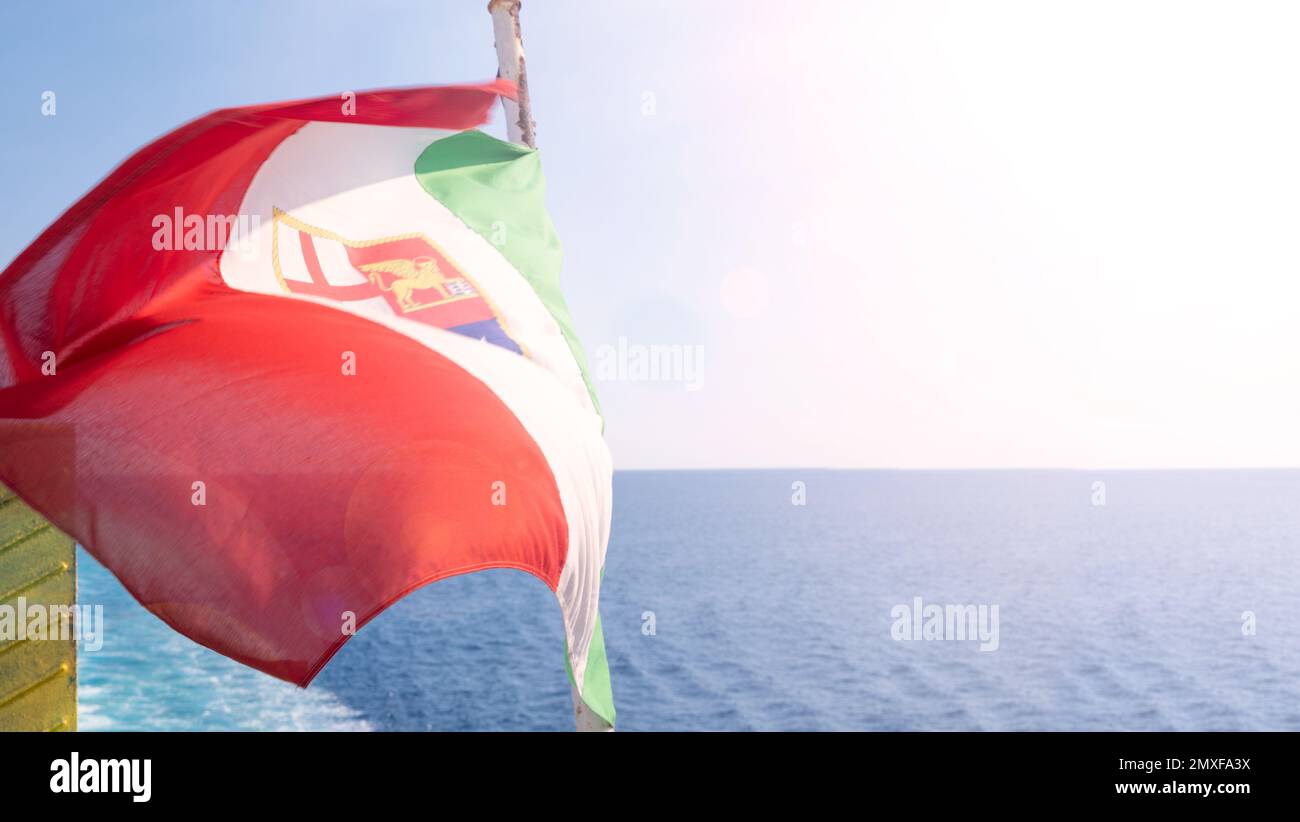 The italy flag flutters in the wind. The symbol of italy on board a ...