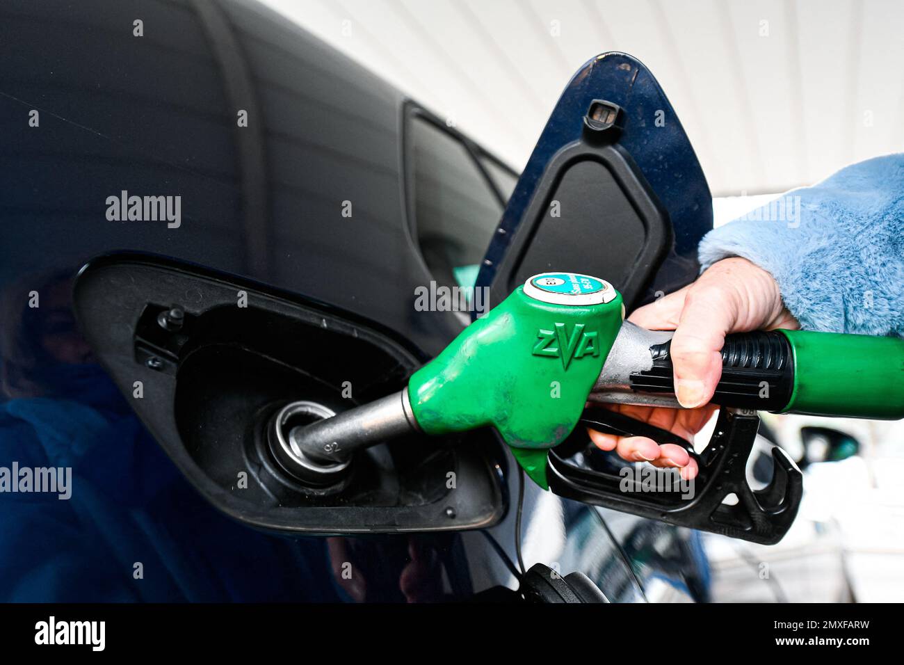 Illustration picture shows a person using a petrol pump (unleaded fuel ...
