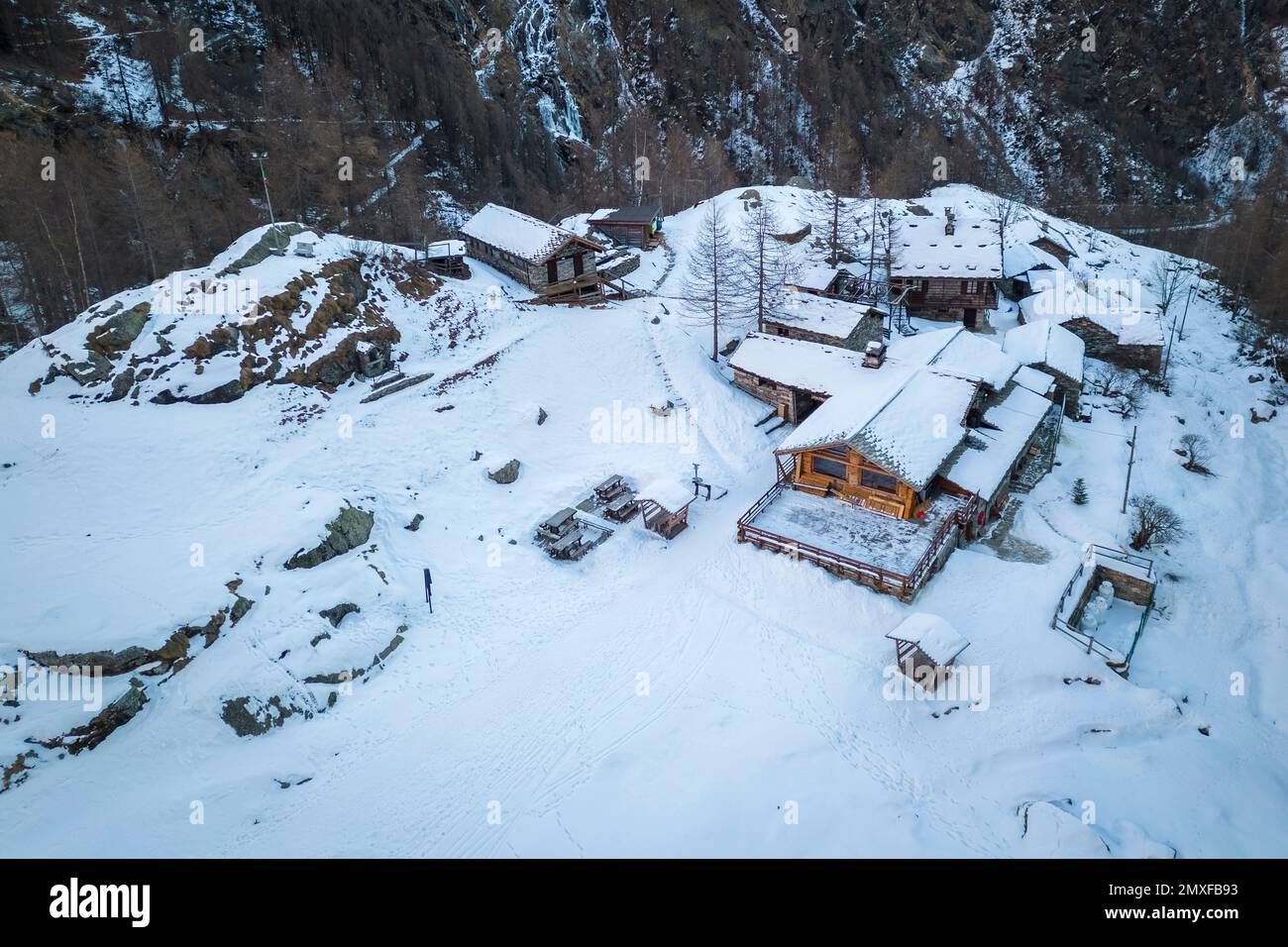 Aerial view of the Pastore Refuge at dawn in winter. Alpe Pile, Alagna ...
