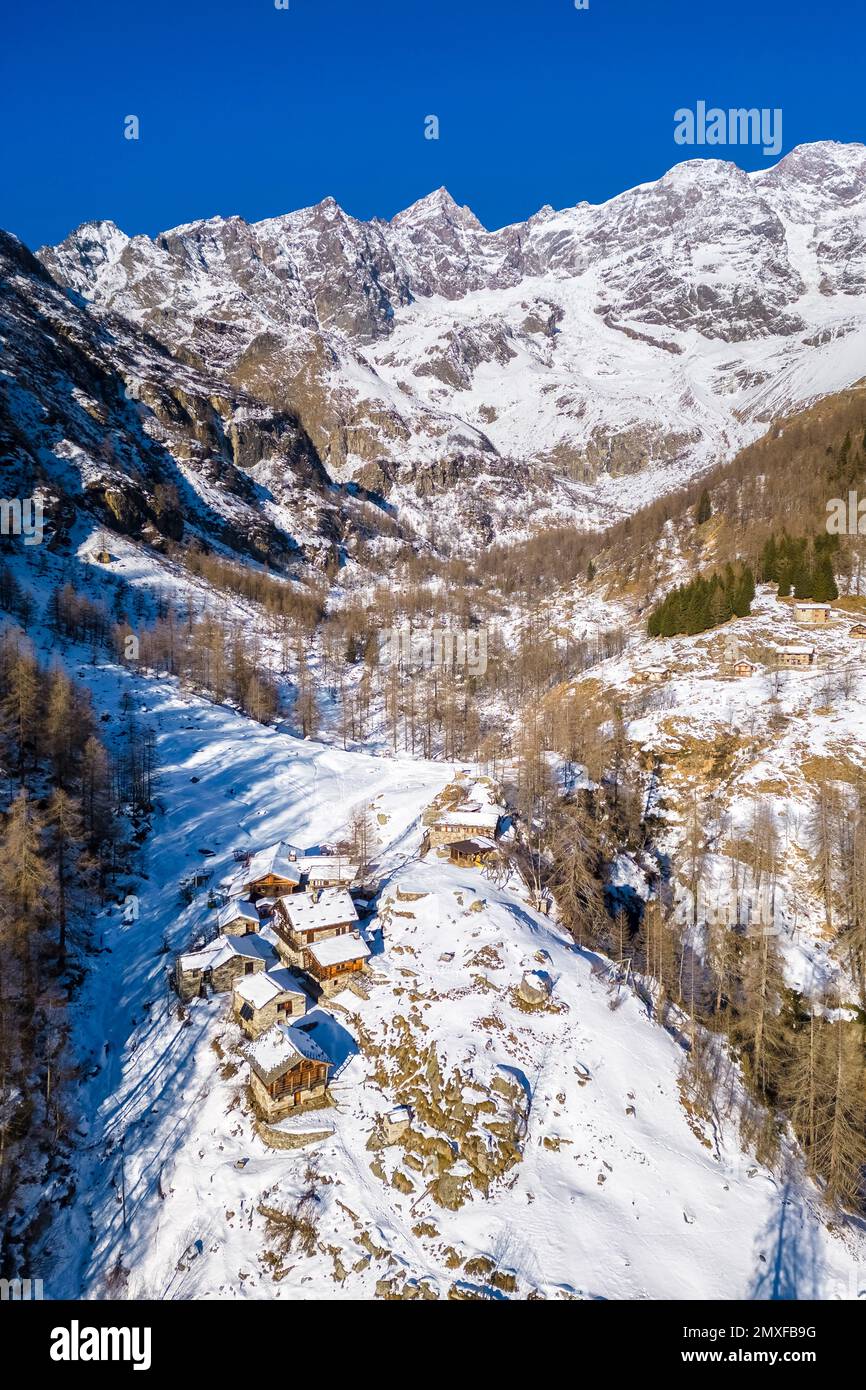Aerial view of the Pastore Refuge and Monte Rosa at dawn in winter ...