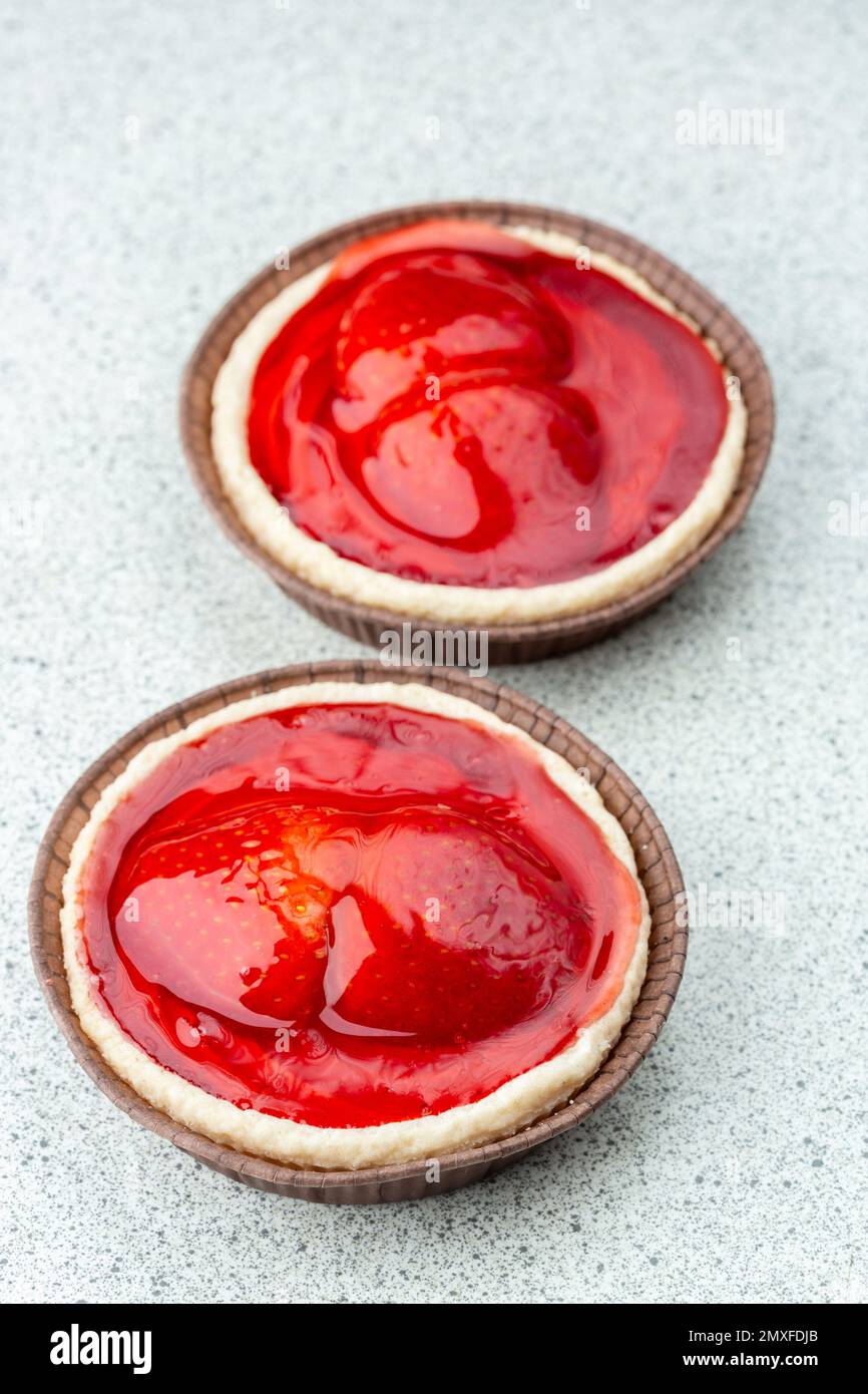 A close up of two bright red strawberry tarts Stock Photo - Alamy