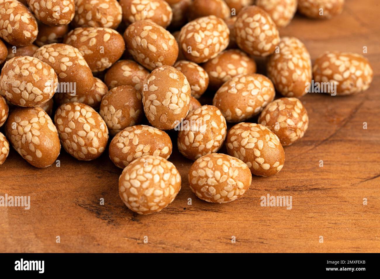 Pile of Crunchy Asian Sesame Peanuts with Soy Sauce on a Wooden Counter ...