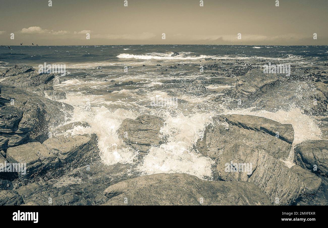 False Bay rough coast landscape with boulders waves and mountains with ...