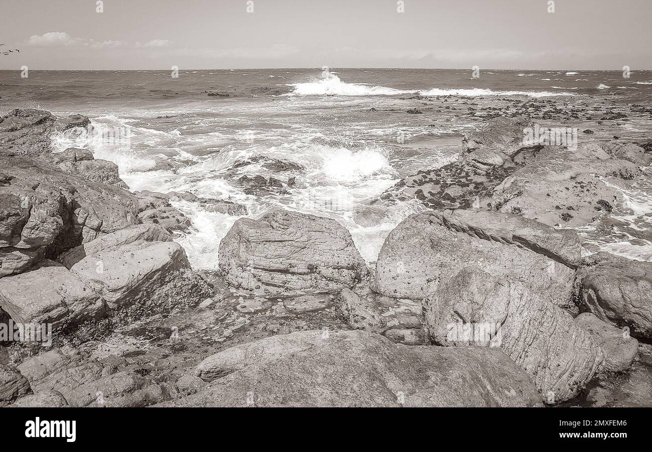False Bay rough coast landscape with boulders waves and mountains with ...
