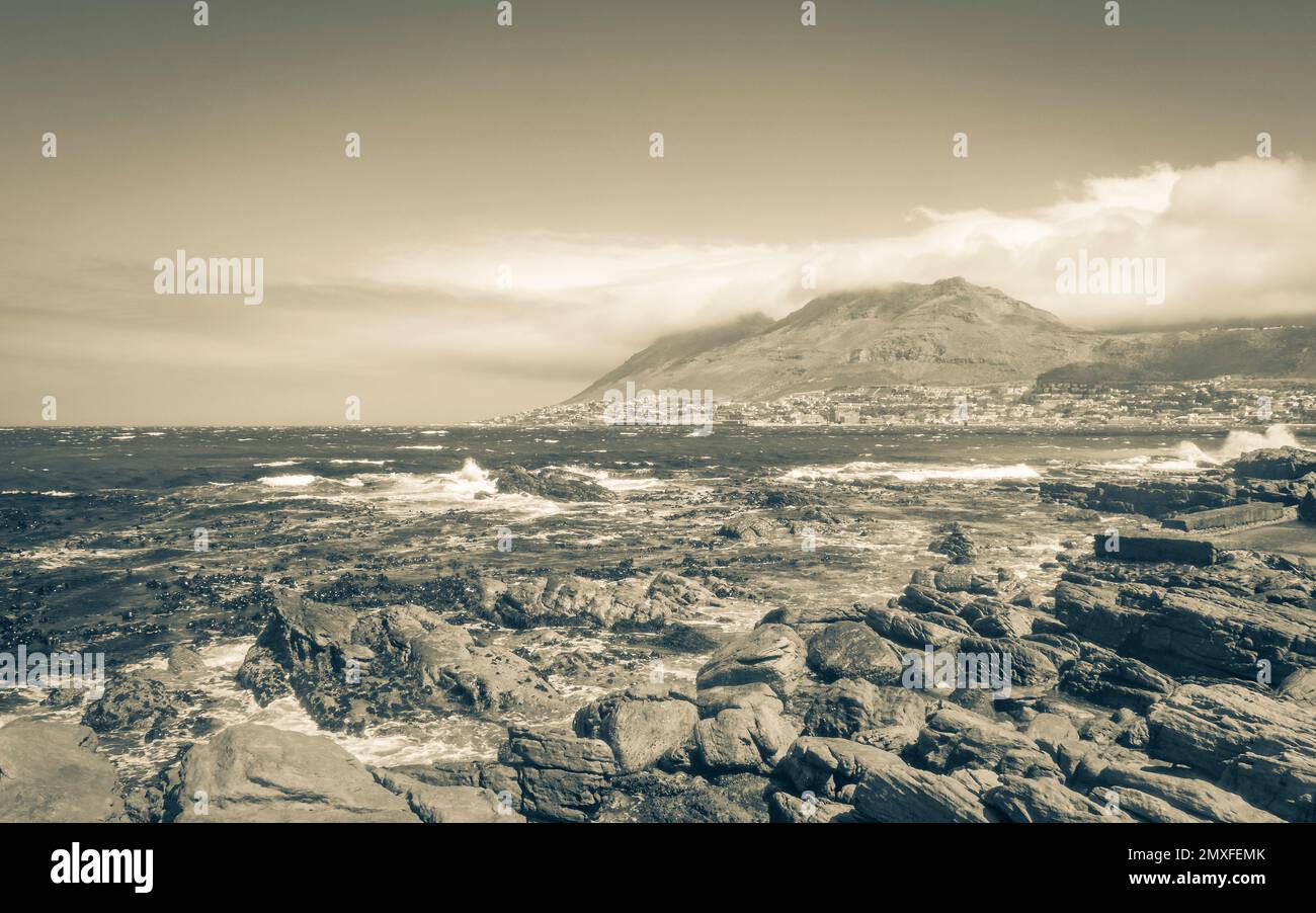 False Bay rough coast landscape with boulders waves and mountains with ...