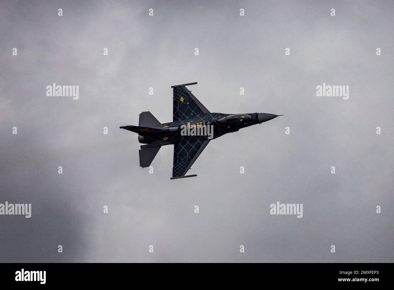 The F-16 Viper demo team aircraft flying in Houston against a clouded ...