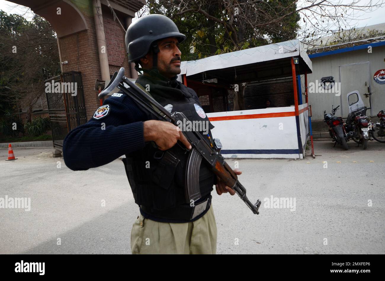 PESHAWAR PAKISTAN, JANURAY, 01: A policeman searches a man at the entry ...