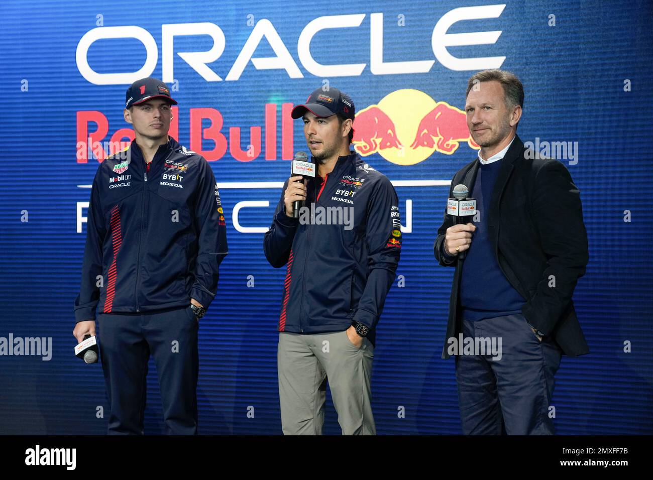 Red Bull Racing drivers Max Verstappen, left, and Sergio Perez, center ...