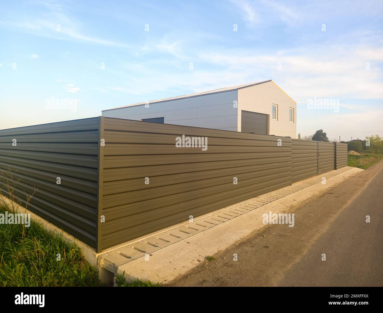 Warehouse building with fence. Industrial warehouse Stock Photo - Alamy