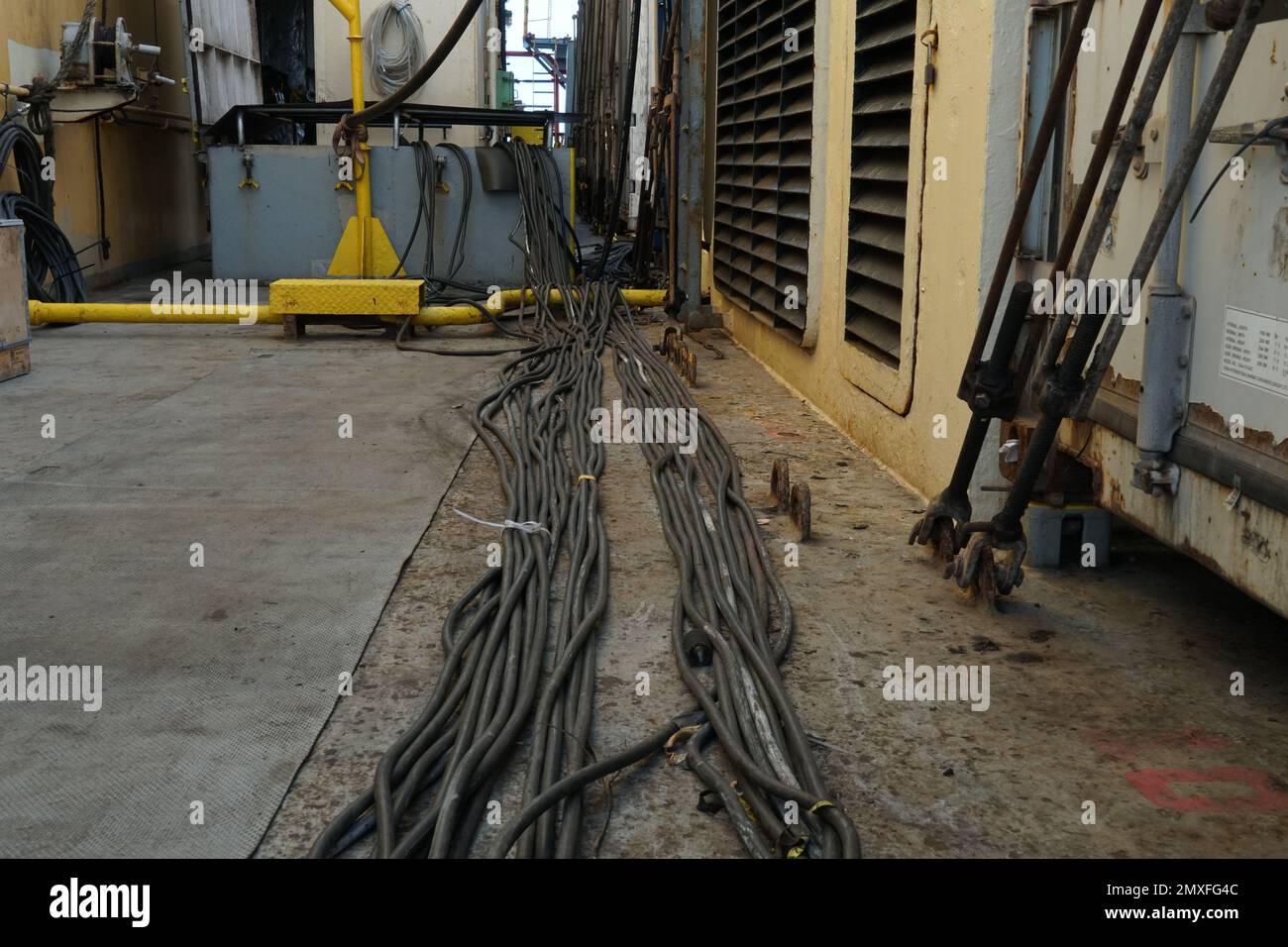 Spaghetti of black cables extended on the main deck from white reefer ...