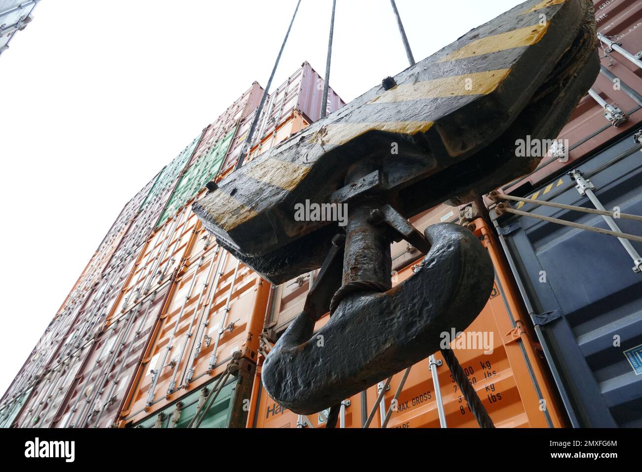 View on the black steel hook of ship's cargo crane secured on main deck ...
