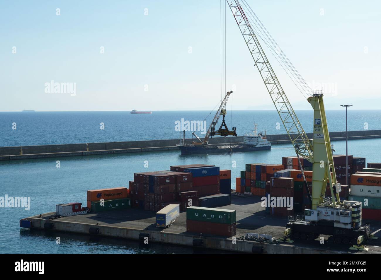 View on movable cargo crane with spreader to handling containers ...