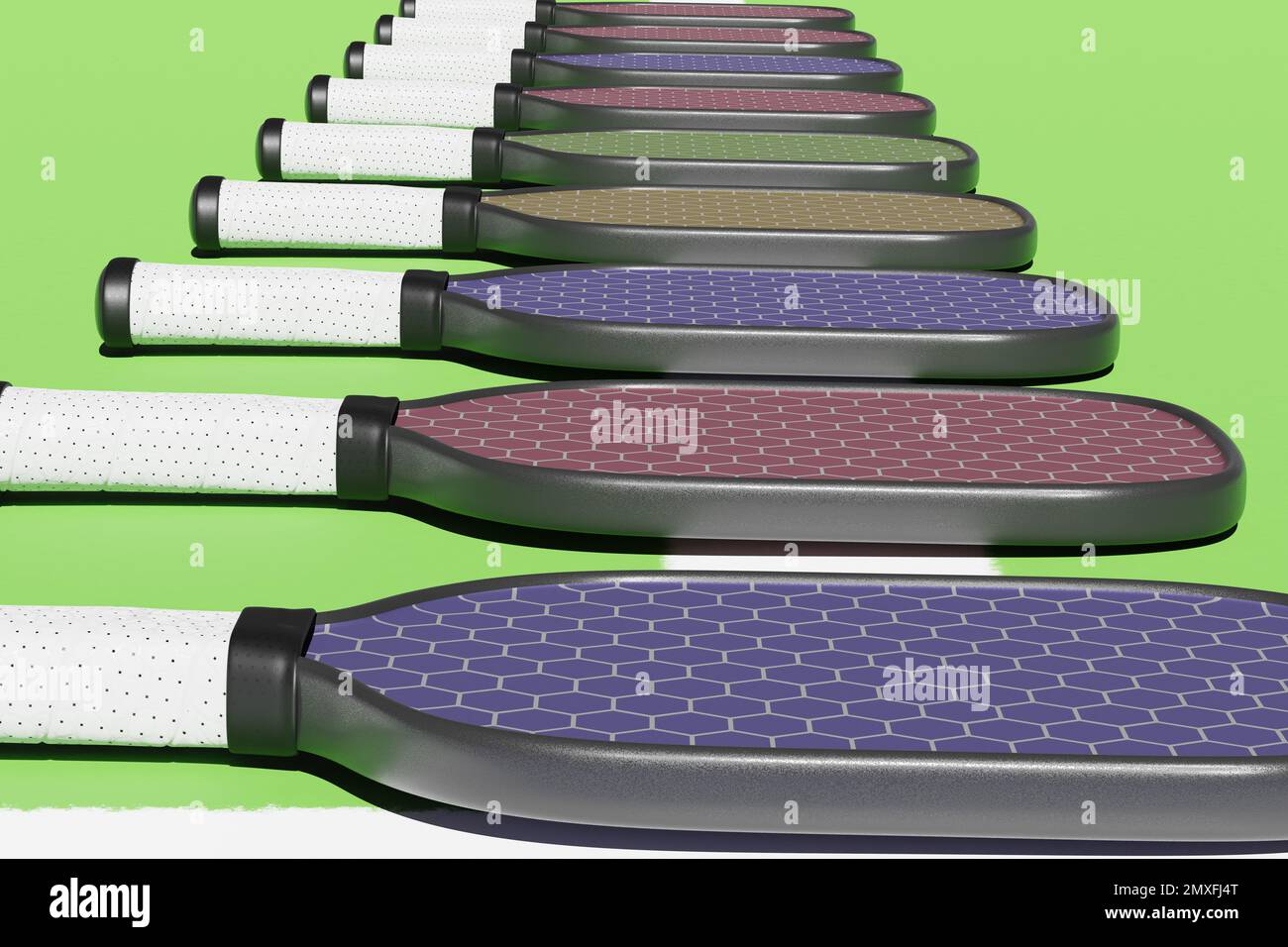 Pickleball different rackets lying in a line on a sports playground ...