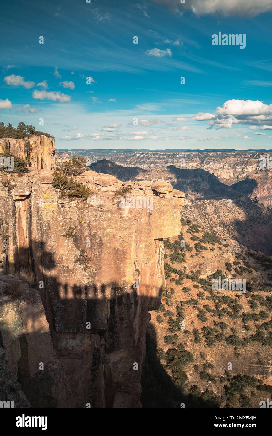 An aerial shot of Copper Canyon and the shadow of tourists on the red ...