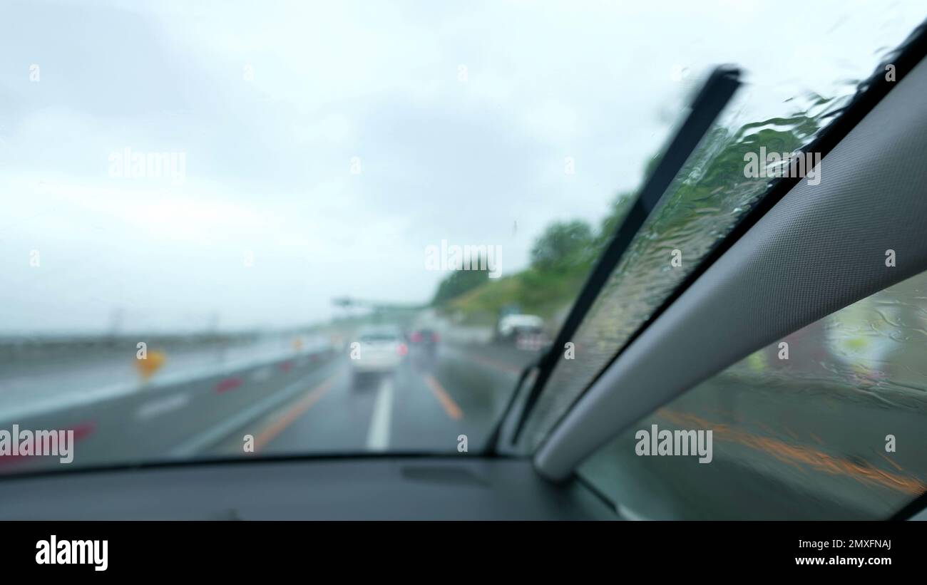 Driving during rain on road windshield closeup Stock Photo - Alamy