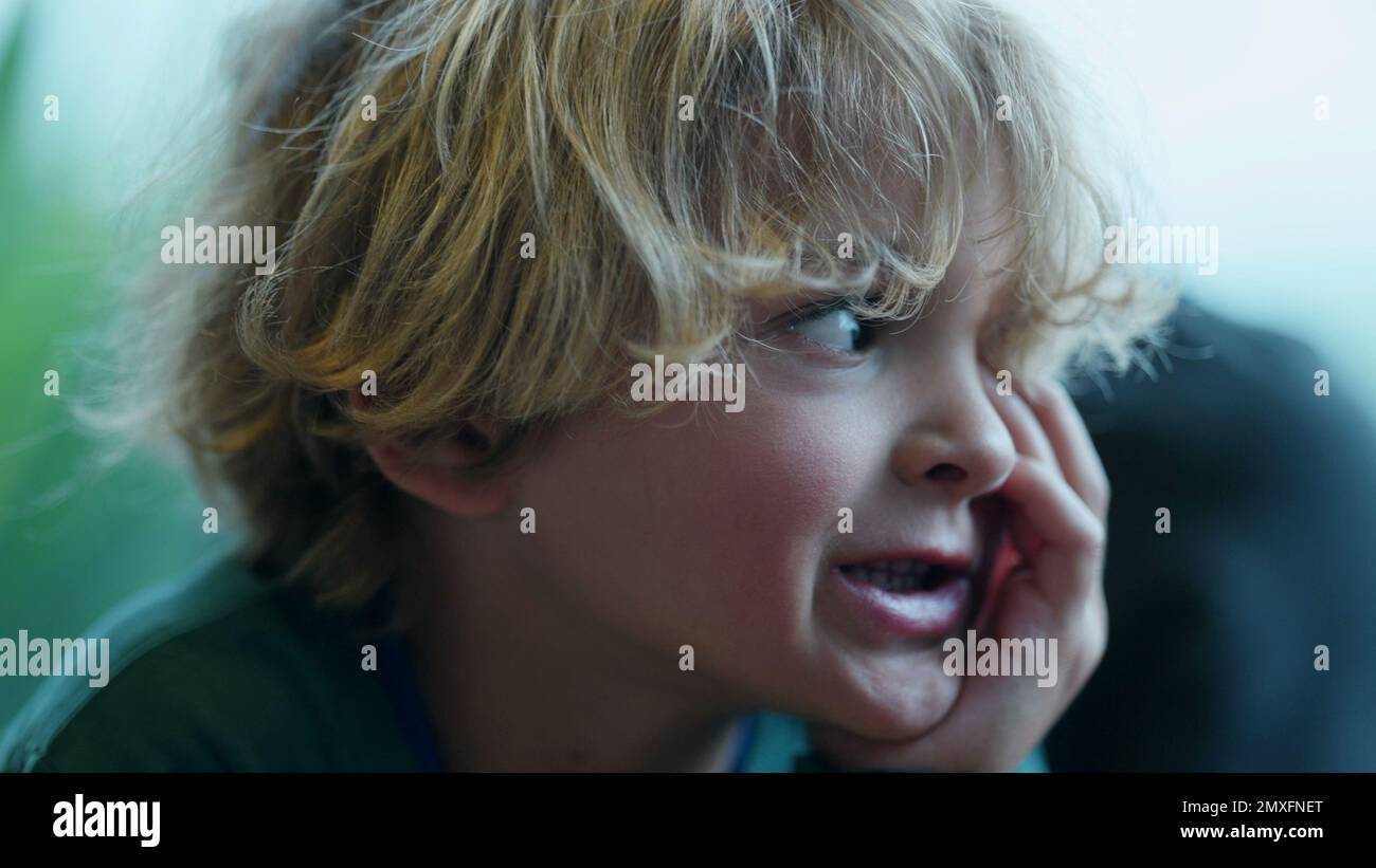 Bored kid face closeup child rubbing eye handsome child boy feeling ...