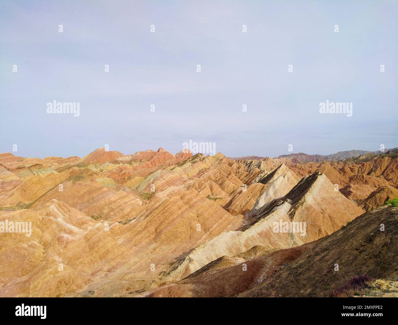 The colorful peaks of the mountains in Danxia Landform on a sunny day ...