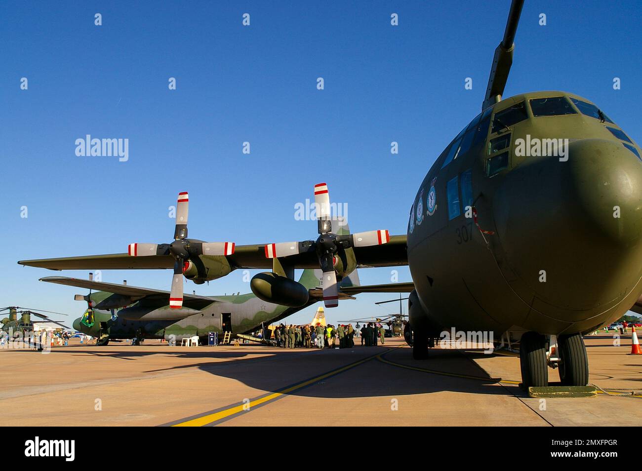 Air Force pilots and crews at after event party under Lockheed C-130 ...