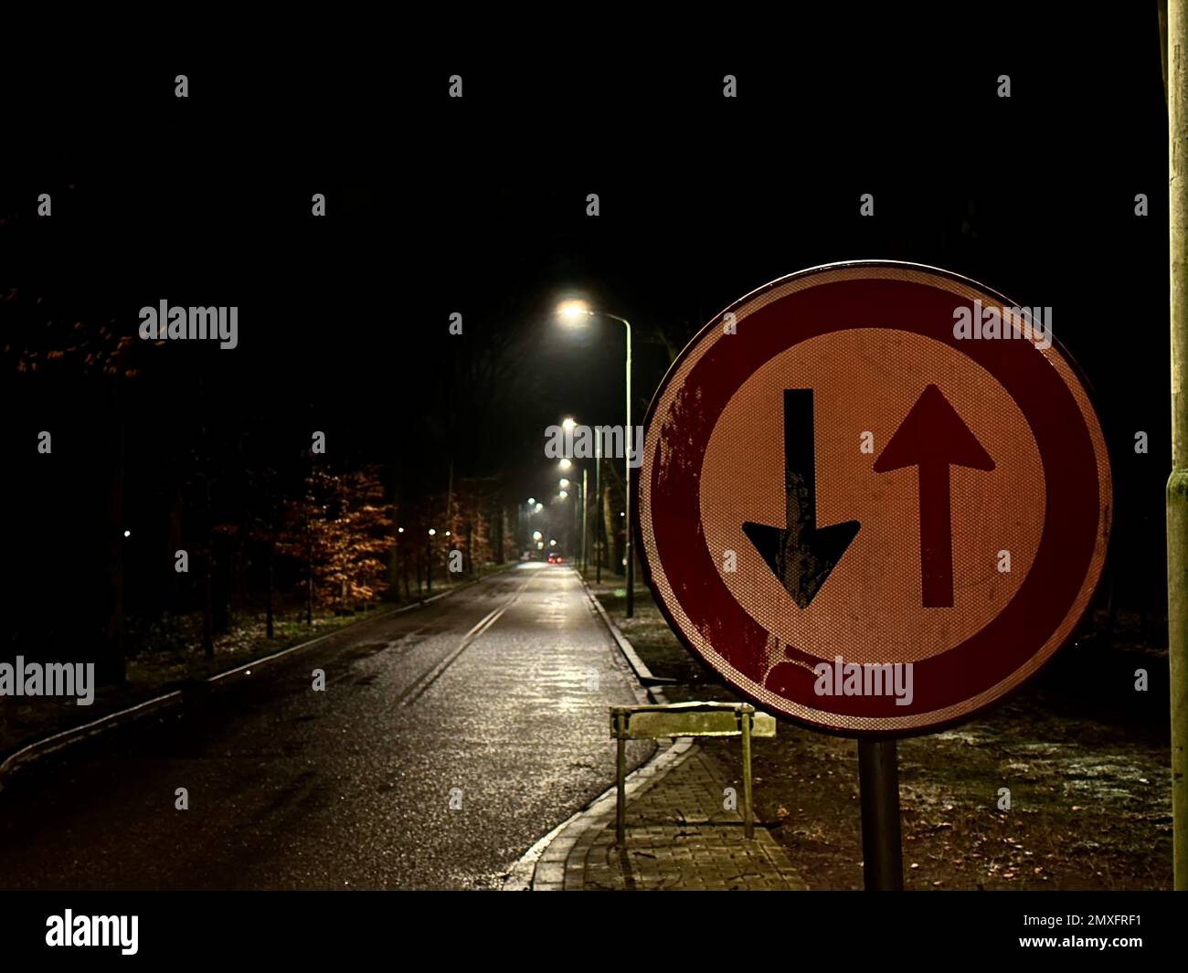 A close-up shot of the give way to oncoming traffic sign on the road ...