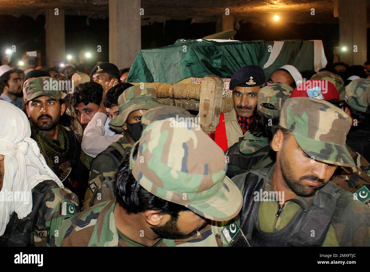 Pakistan army soldiers carry a coffin of their colleague who was killed ...