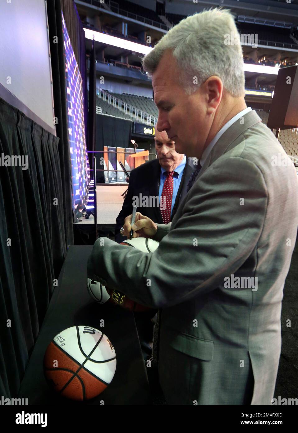 Kansas State coach Bruce Weber signs basketballs during Big 12 NCAA ...