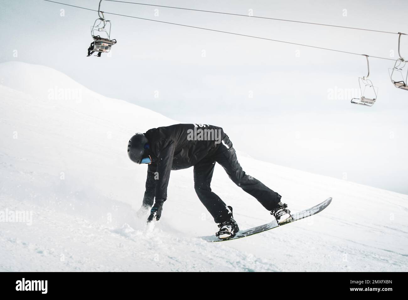 Extreme winter sports. Young professional male snowboarder rides ...