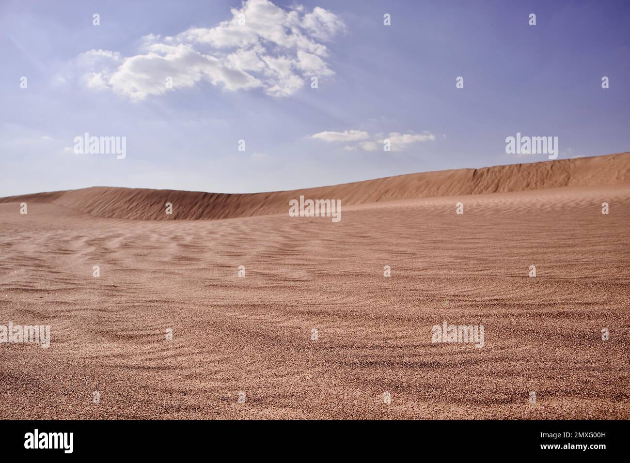 A daytime view of sand dunes in a desert Stock Photo - Alamy