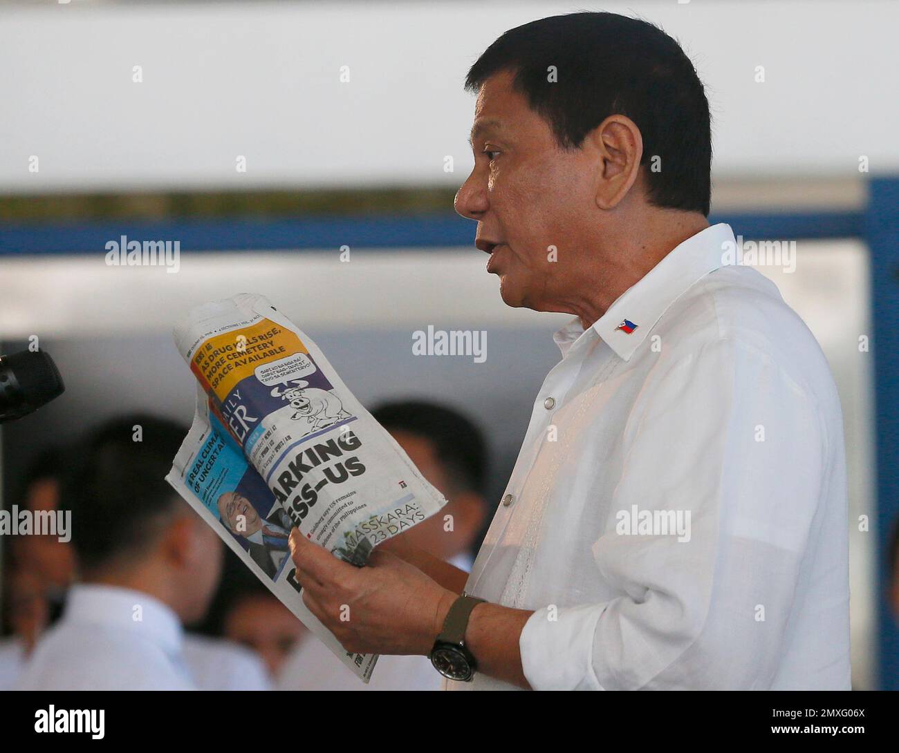 Philippine President Rodrigo Duterte holds a copy of a the Philippine ...