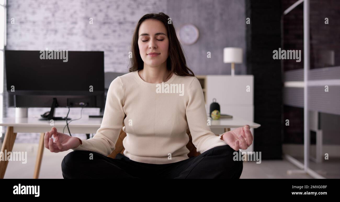Employee Doing Mental Health Yoga Meditation In Office Stock Photo - Alamy