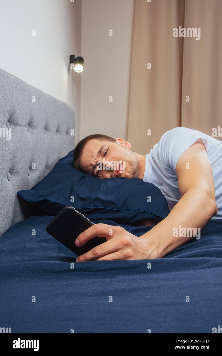 Happy young cheerful man in pajamas wearing a sleep mask. Rest, rest at ...