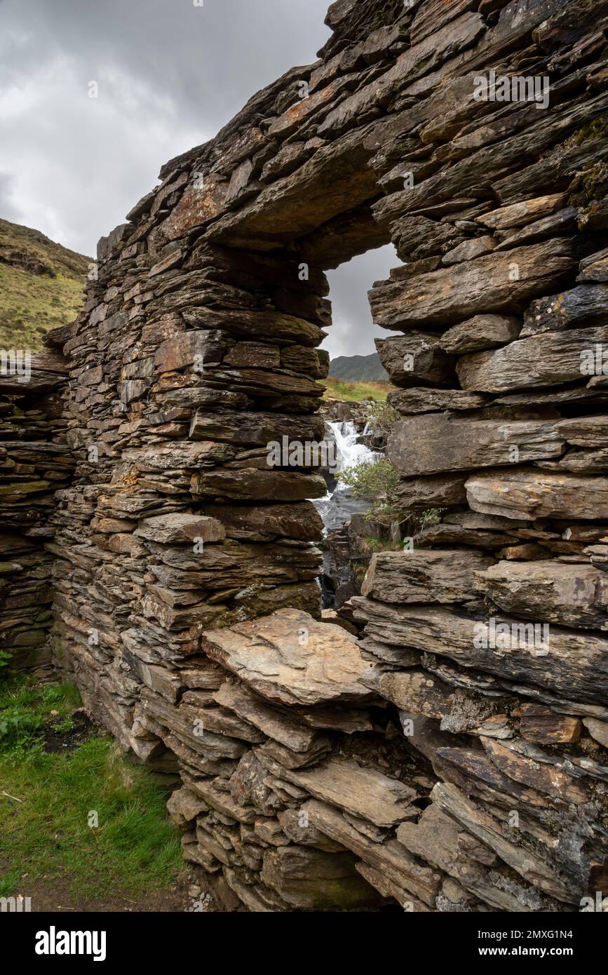 Old stone ruins by the stream on the Watkin Path in Cwm Llan. Seen by ...