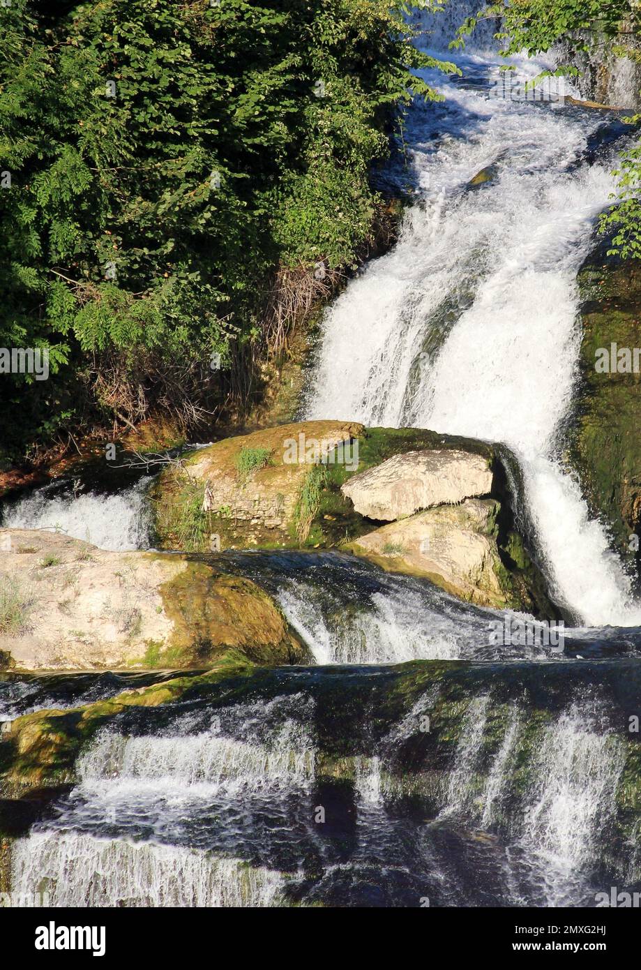Wild waterfall over the rock in nature park Stock Photo - Alamy
